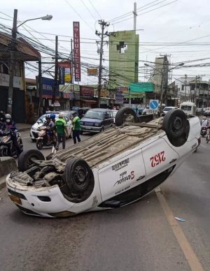 Driver, whose taxi flipped over at the foot of the Tabunok flyover, is ...